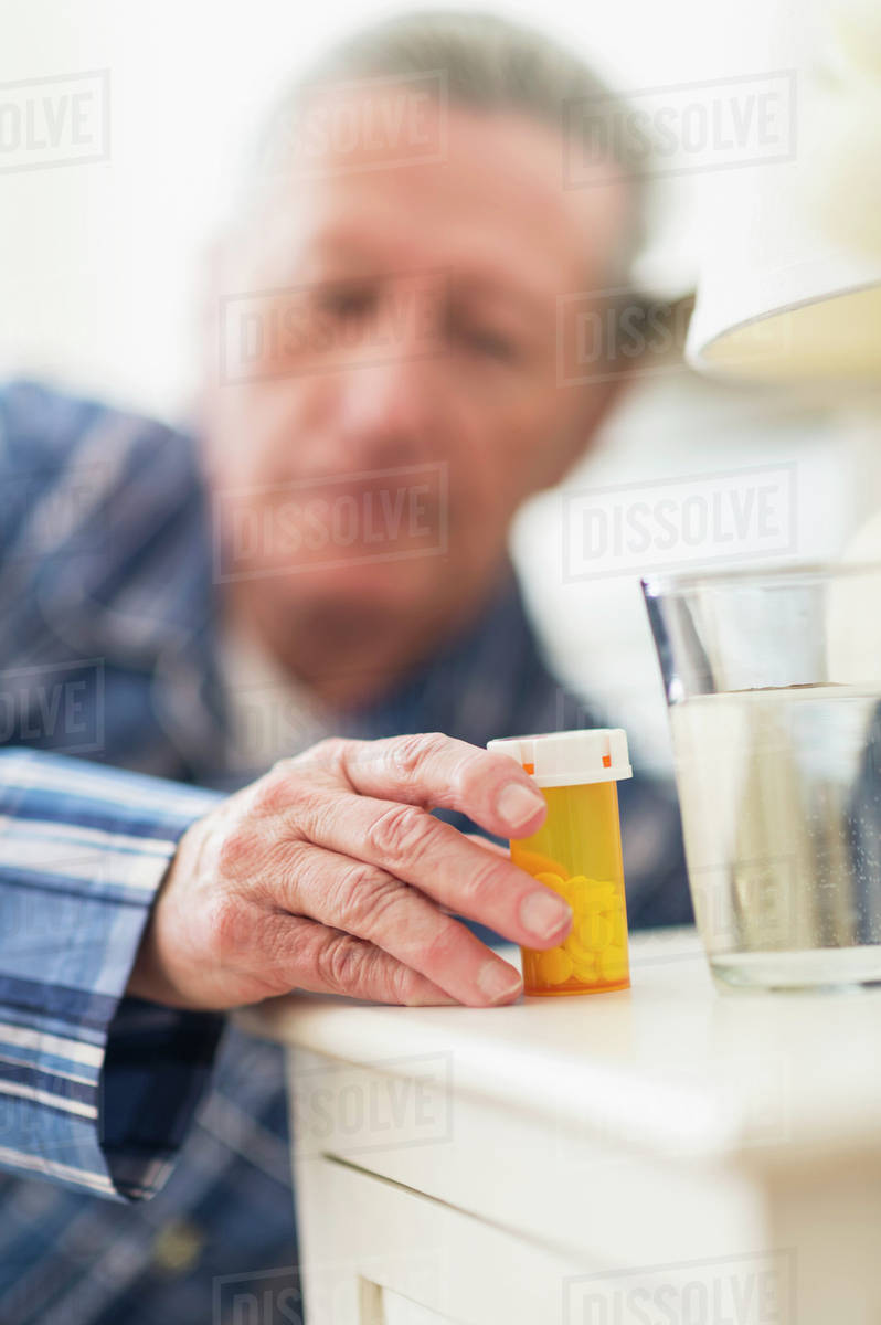 Senior Caucasian man taking medication - Royalty-free Stock Photo ...