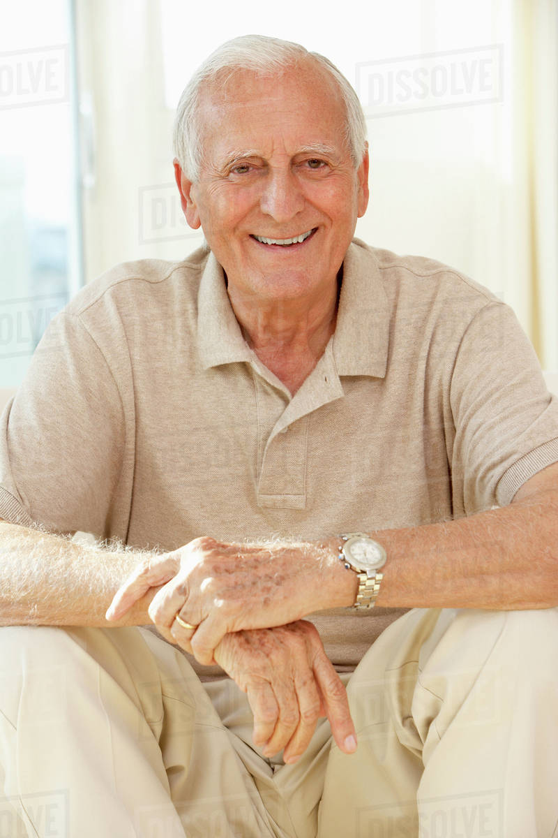 Senior man sitting on sofa - Royalty-free Stock Photo | Dissolve