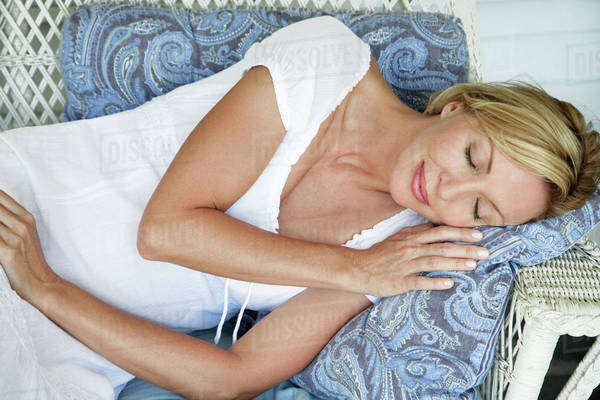 Woman napping on sofa - Royalty-free Stock Photo | Dissolve