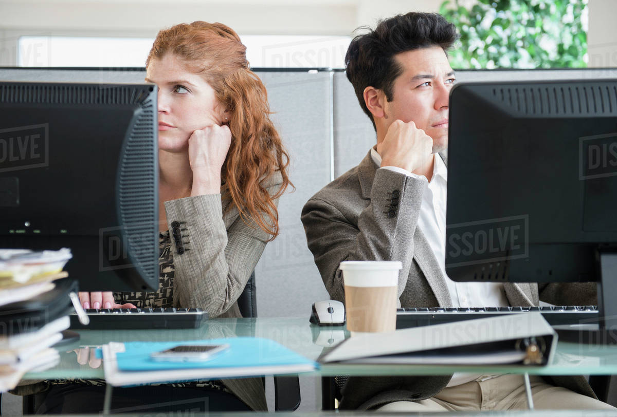 Business people bored at desks - Royalty-free Stock Photo | Dissolve