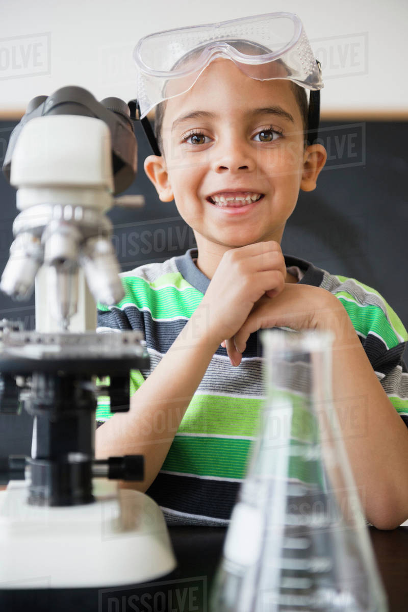 Mixed race boy doing experiments in science class - Royalty-free Stock ...