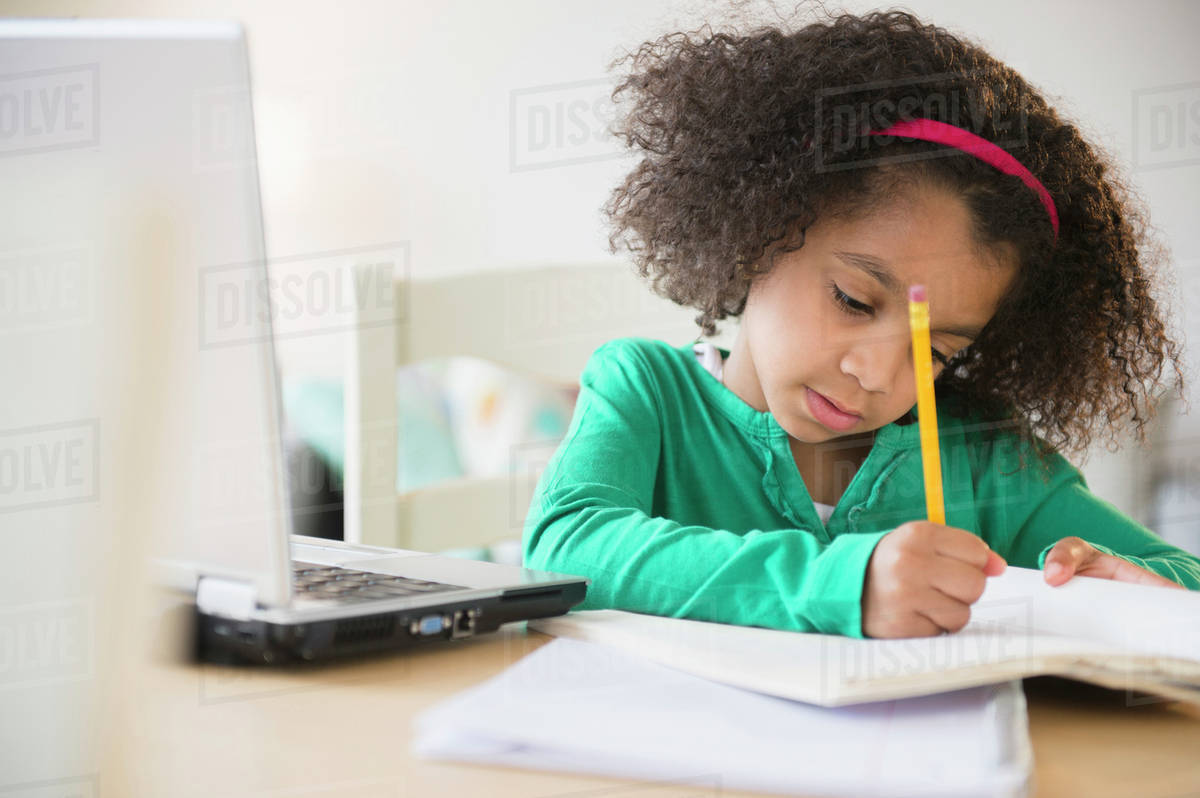 African American girl doing homework with laptop - Royalty-free Stock ...