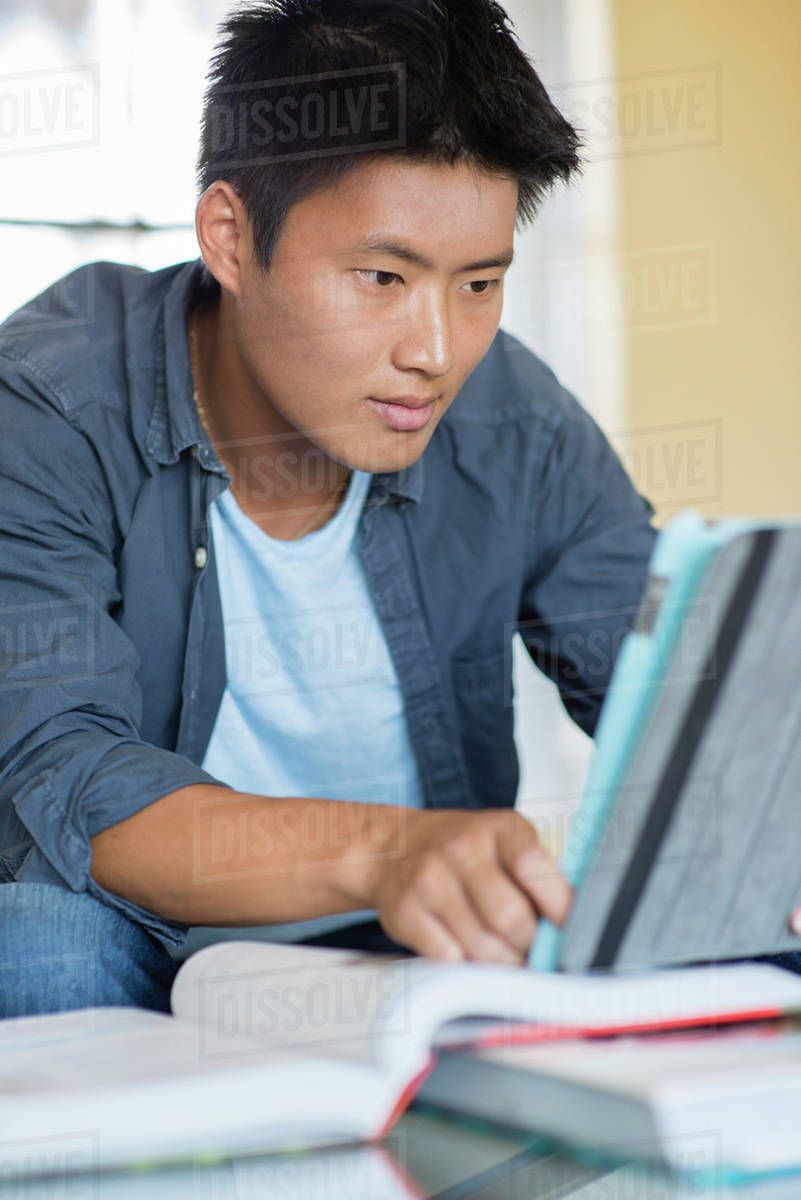 Korean man doing homework with digital tablet - Royalty-free Stock ...
