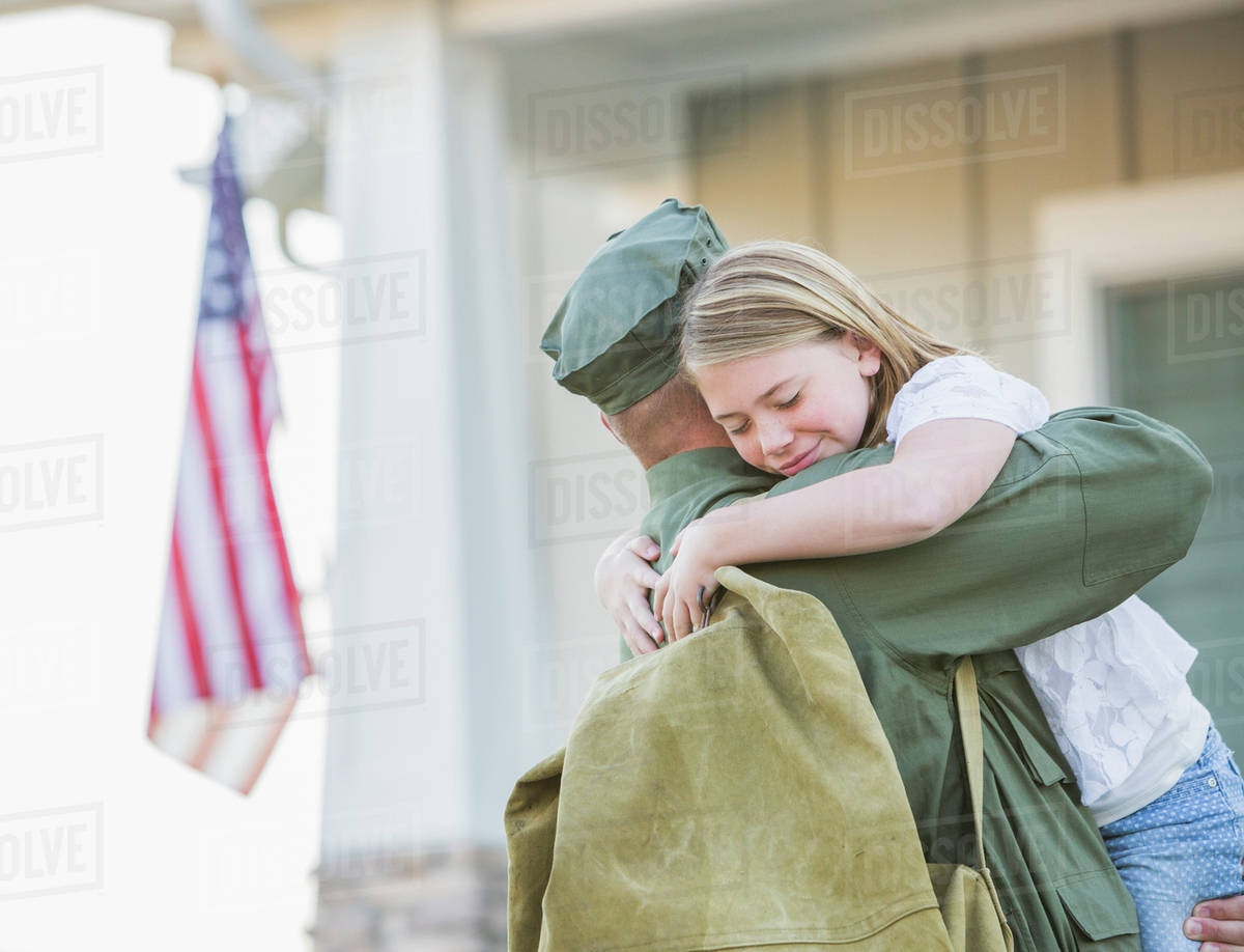 Returning Caucasian soldier hugging daughter - Royalty-free Stock Photo ...