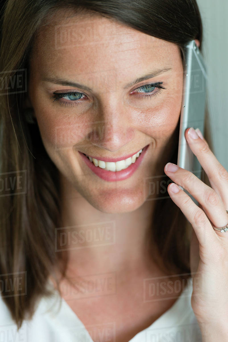 Caucasian woman talking on cell phone - Royalty-free Stock Photo | Dissolve