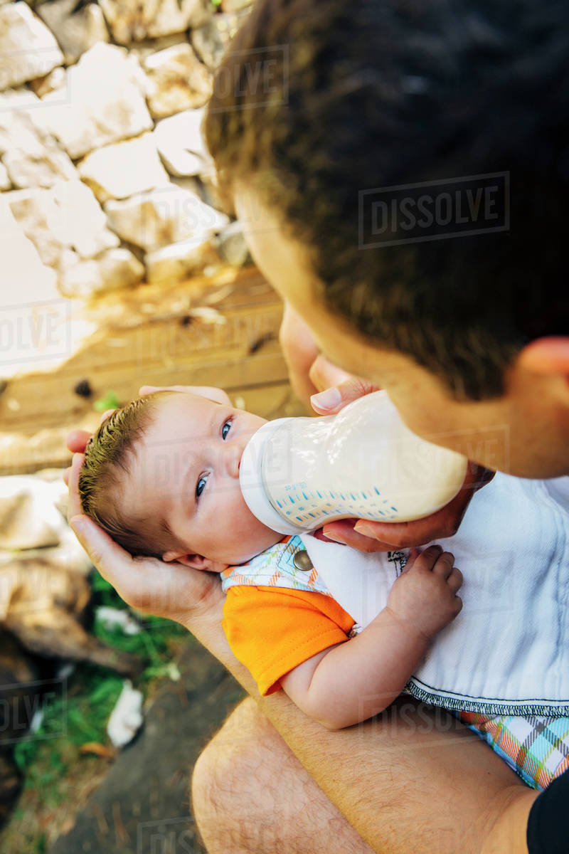 Caucasian father feeding baby boy outdoors - Royalty-free Stock Photo ...