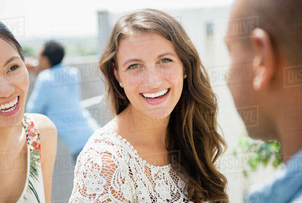 Woman smiling at party - Stock Photo - Dissolve
