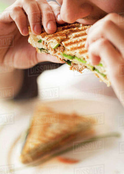Close up of woman eating sandwich - Royalty-free Stock Photo | Dissolve