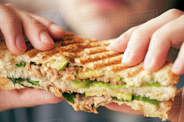 Close up of woman eating sandwich - Royalty-free Stock Photo | Dissolve
