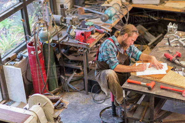 Caucasian craftsman working in workshop - Royalty-free Stock Photo ...