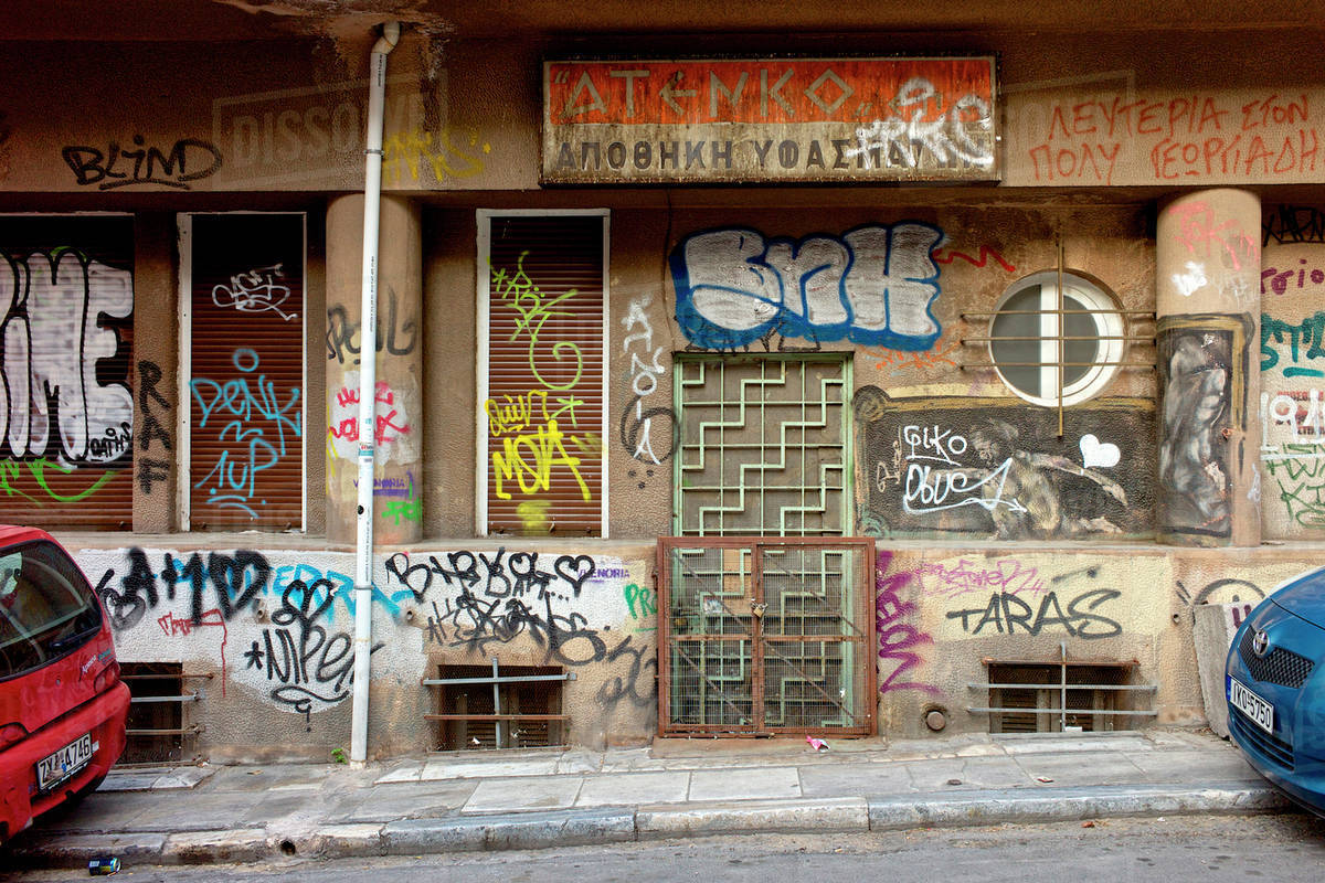 Graffiti covering urban wall in city - Royalty-free Stock Photo | Dissolve