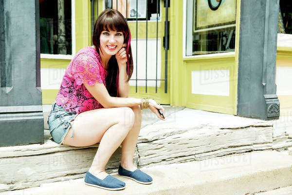 Caucasian woman smiling on front stoop - Royalty-free Stock Photo ...