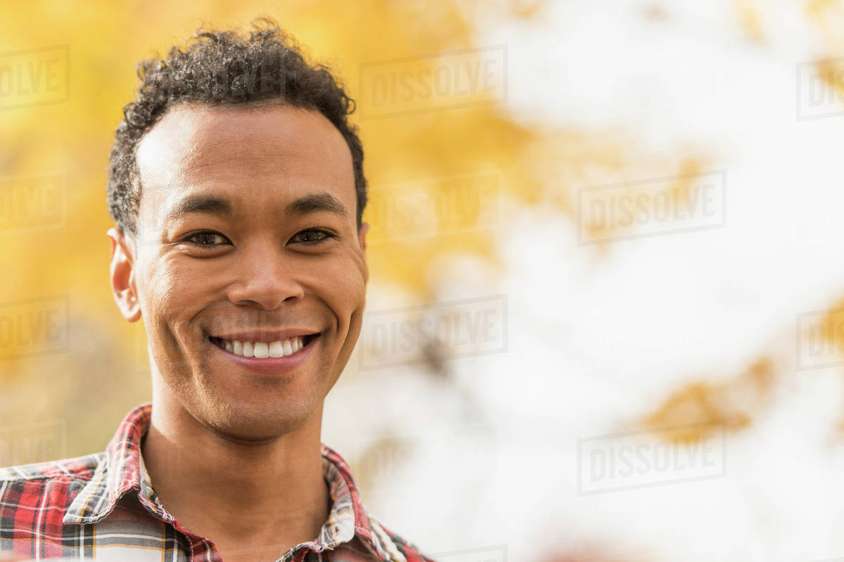 Mixed race man smiling outdoors - Royalty-free Stock Photo | Dissolve
