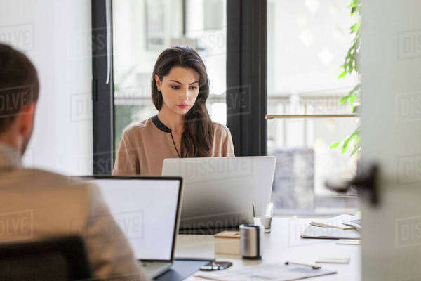 Caucasian business people working at desks in office - Royalty-free ...