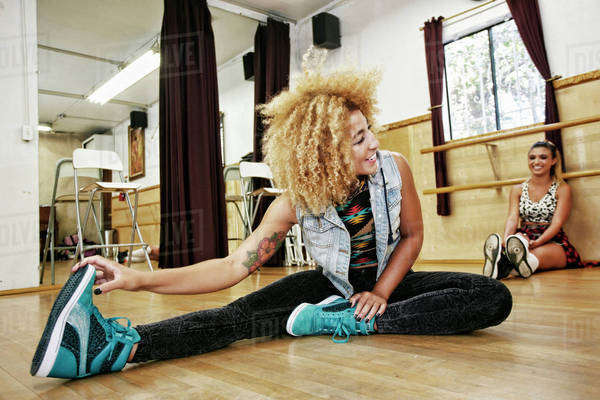 Dancers stretching in studio - Stock Photo - Dissolve