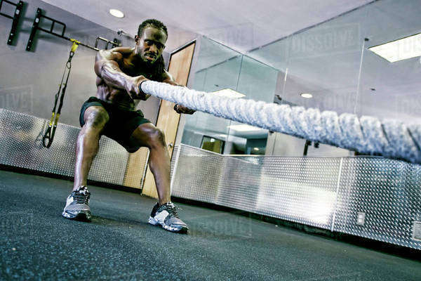 African American man working out with rope in gym - Royalty-free Stock ...