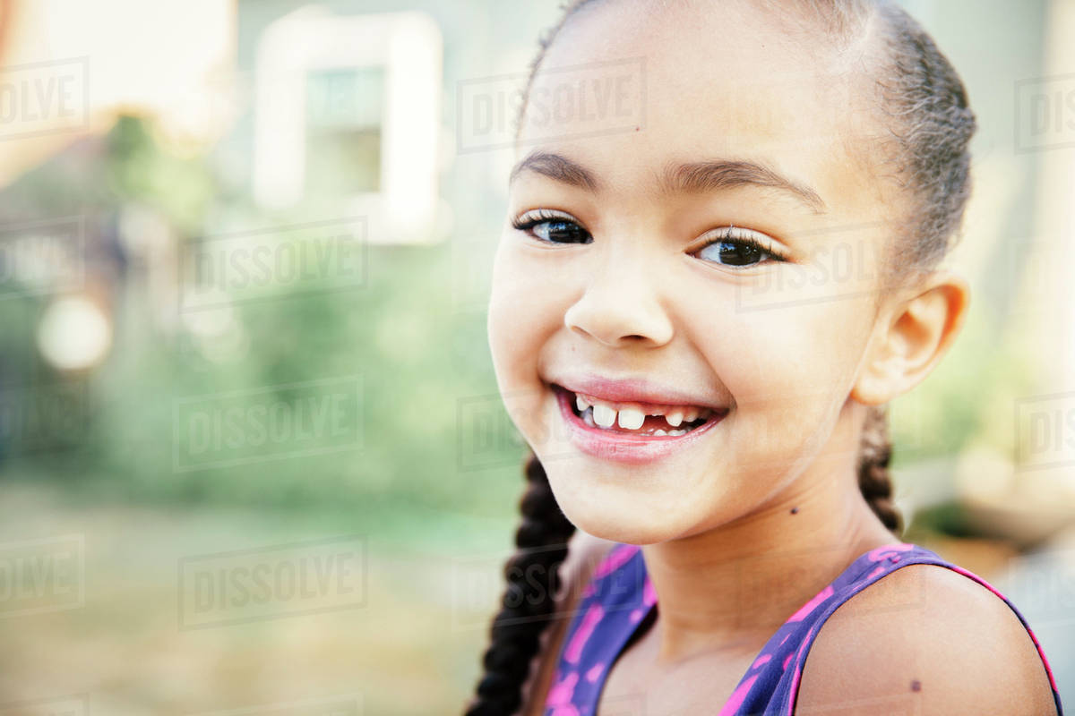 Close up of mixed race girl smiling - Royalty-free Stock Photo | Dissolve