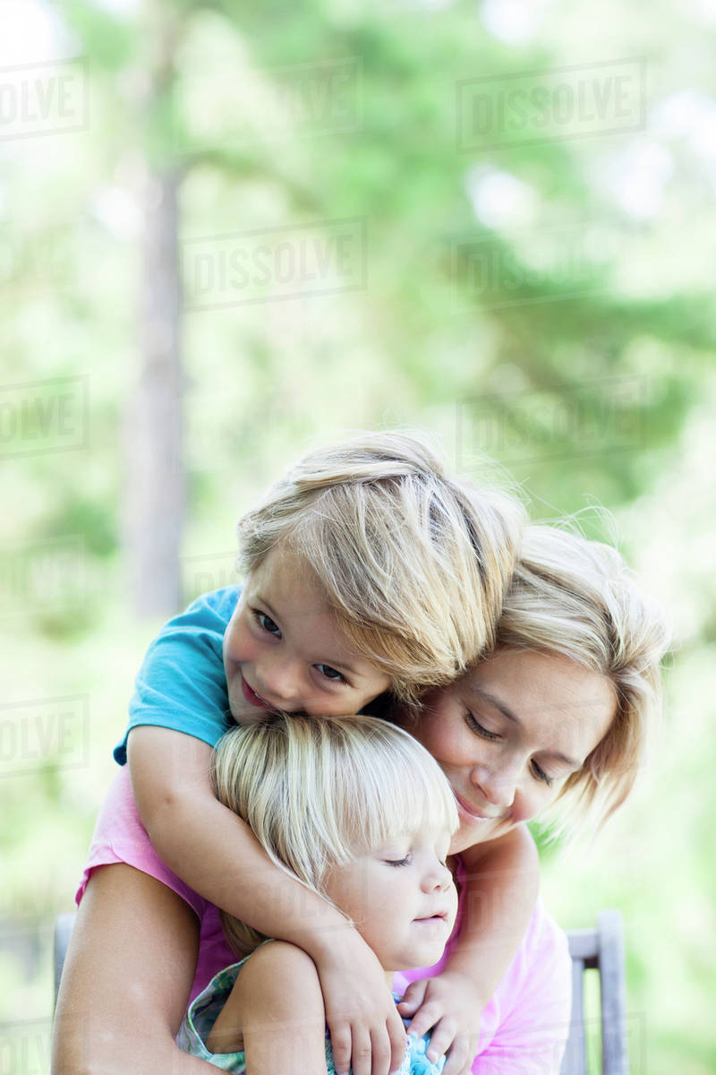 Caucasian mother hugging children outdoors - Royalty-free Stock Photo ...