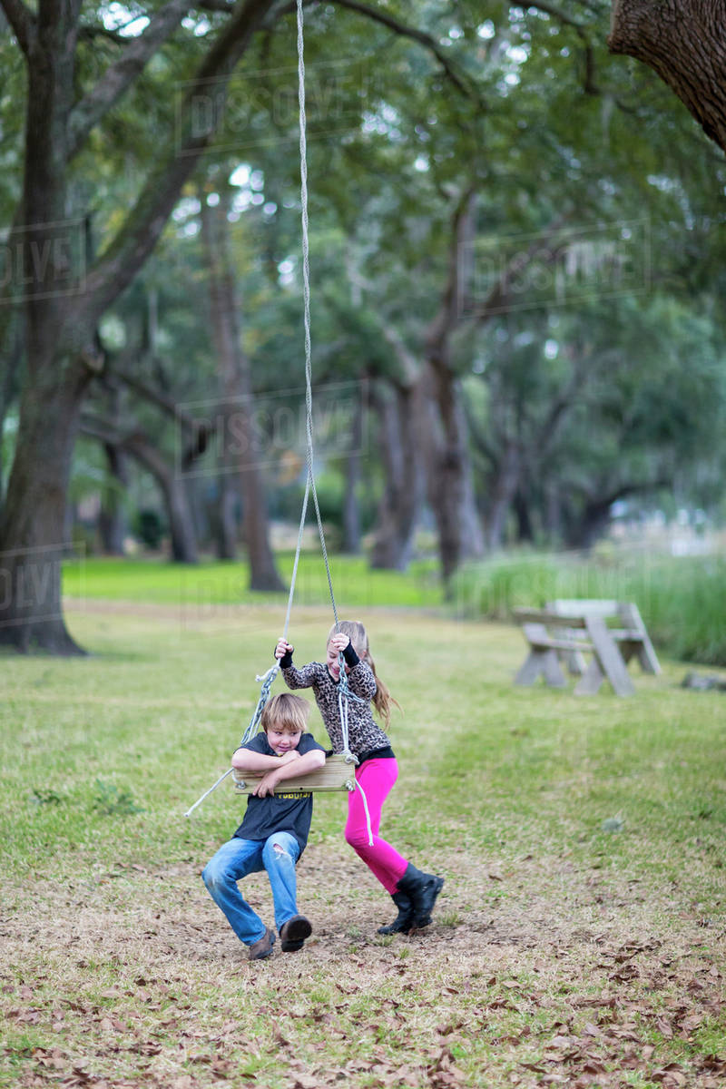 Caucasian children playing on swing in park - Royalty-free Stock Photo ...
