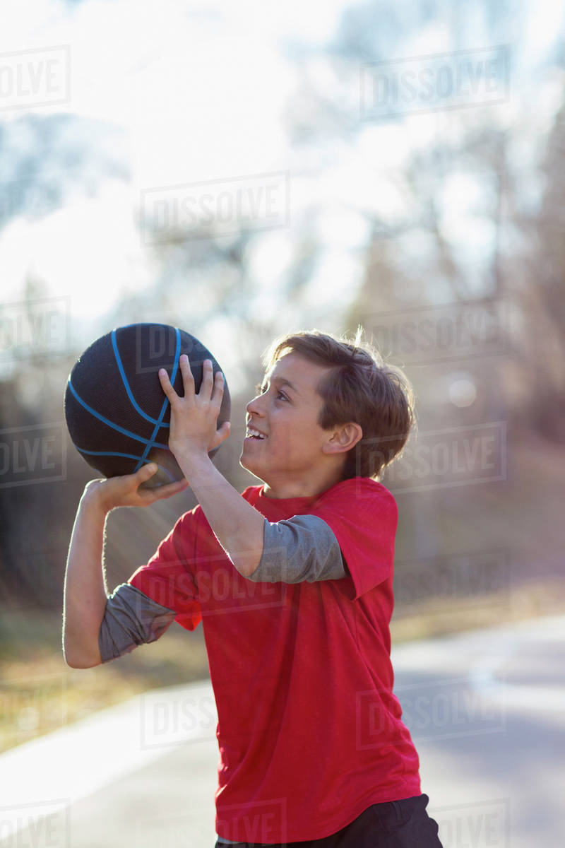 Caucasian boy playing basketball on court - Royalty-free Stock Photo ...