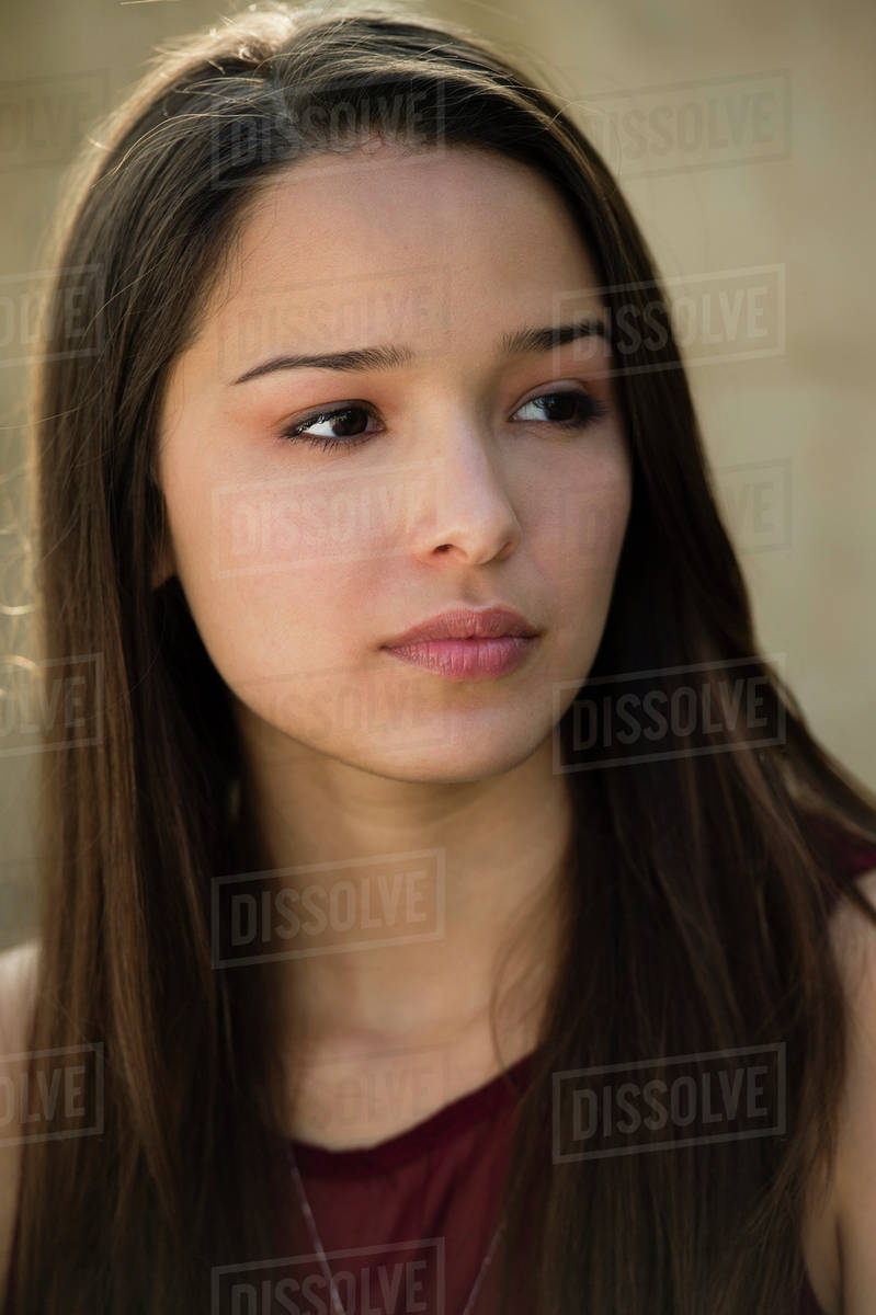 Hispanic woman with worried expression - Stock Photo - Dissolve