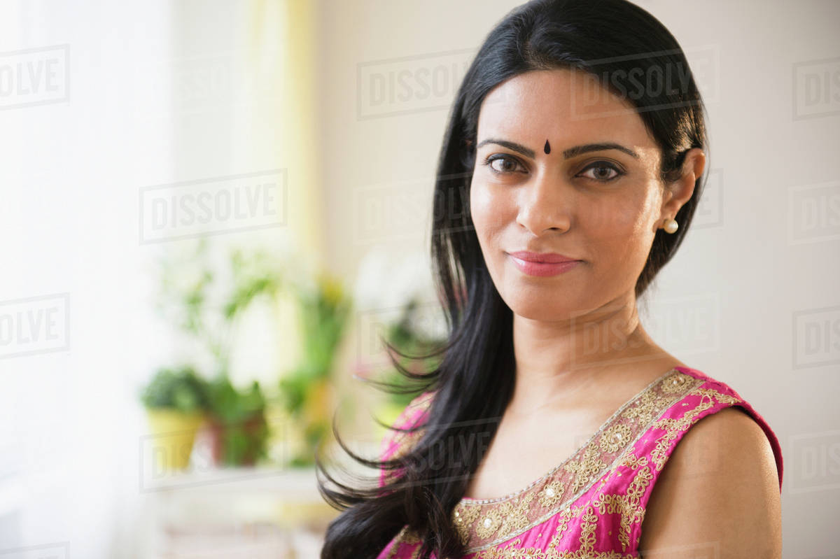 Indian woman wearing bindi and traditional garb - Stock Photo - Dissolve