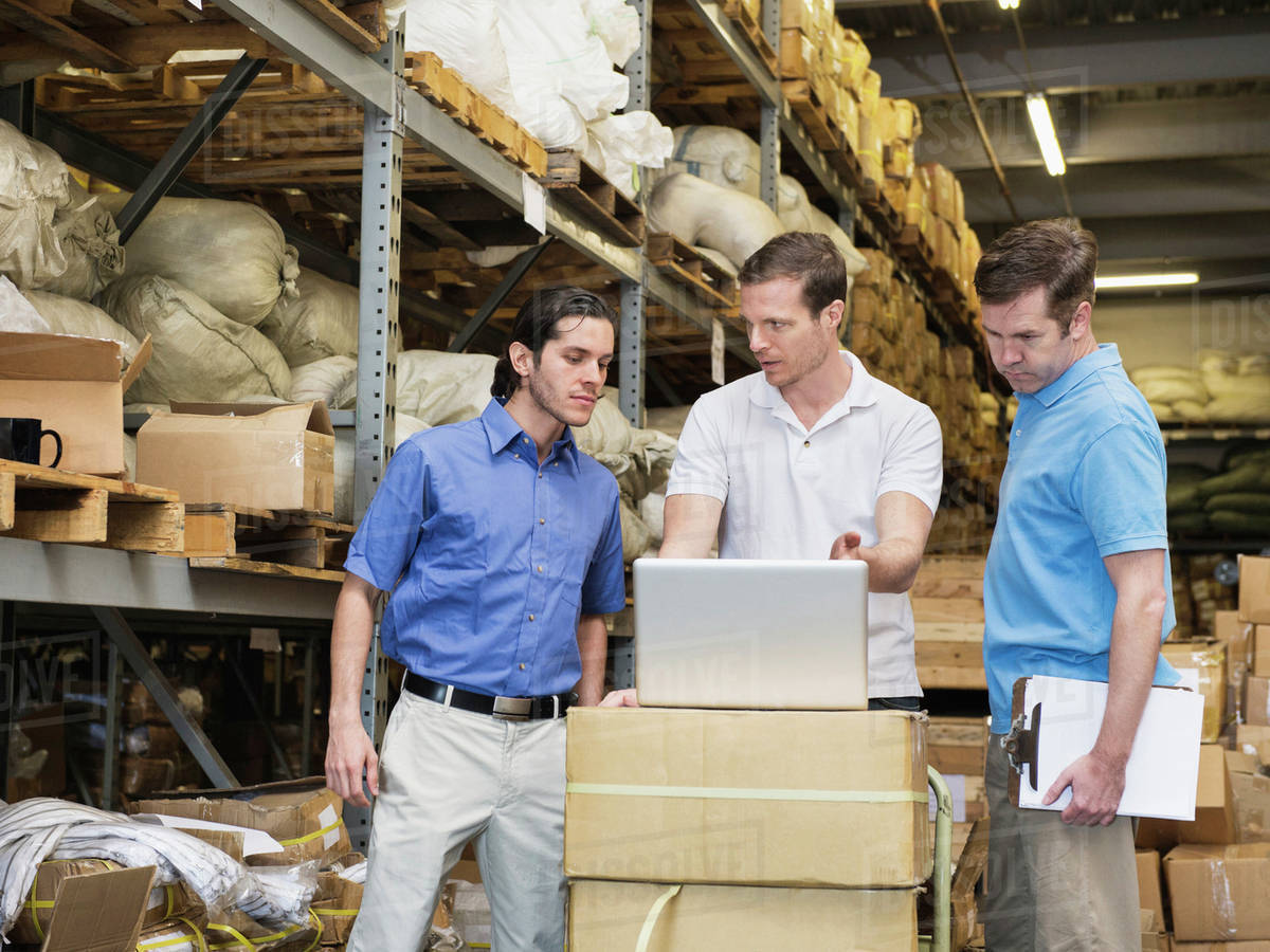 Workers stacking boxes in textile factory - Royalty-free Stock Photo ...