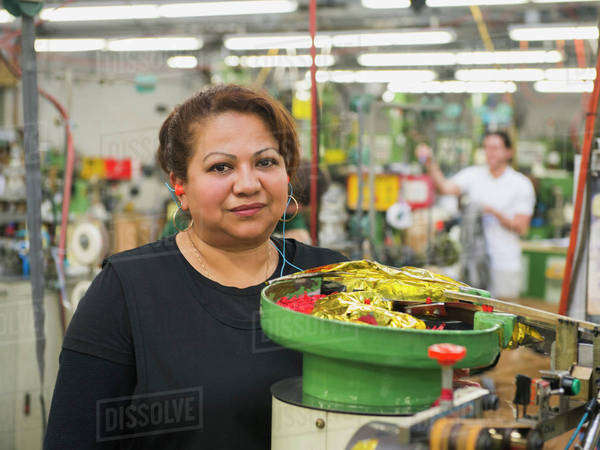 Hispanic worker operating machinery in textile factory - Royalty-free ...