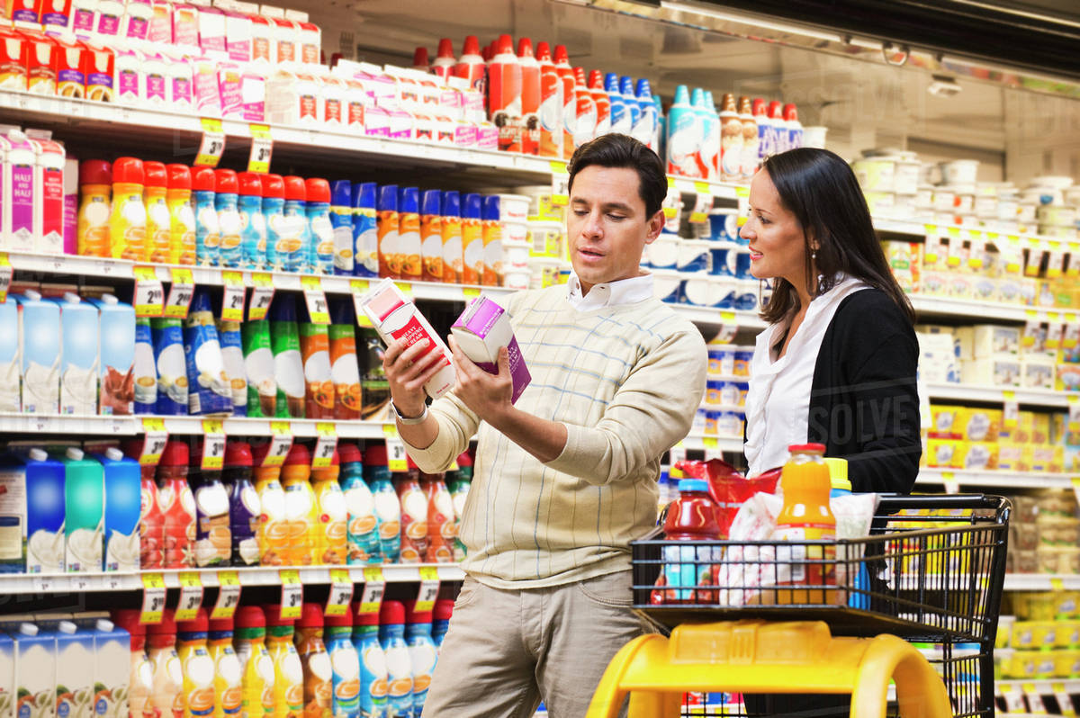 Hispanic couple shopping in grocery store - Stock Photo - Dissolve
