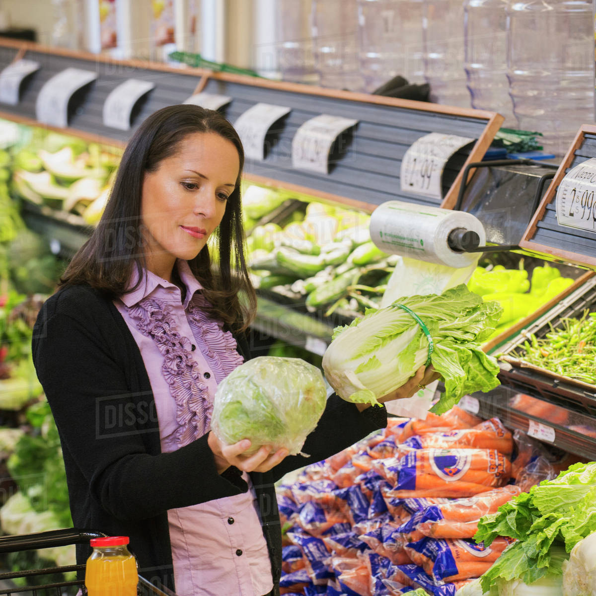 Hispanic woman shopping for produce in grocery store - Royalty-free ...