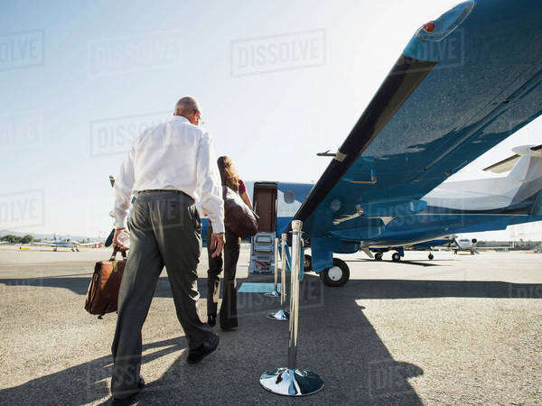 Business people boarding airplane on runway - Royalty-free Stock Photo ...