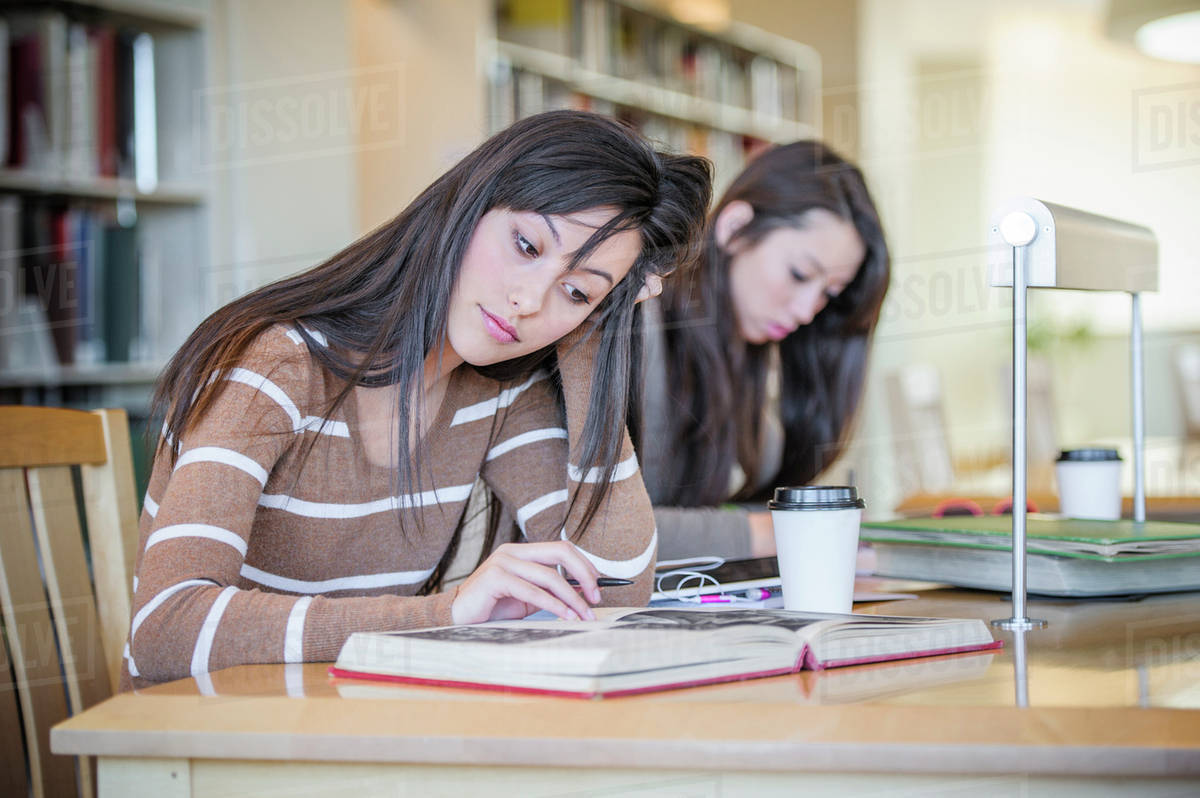 Students working at desk in library - Royalty-free Stock Photo | Dissolve