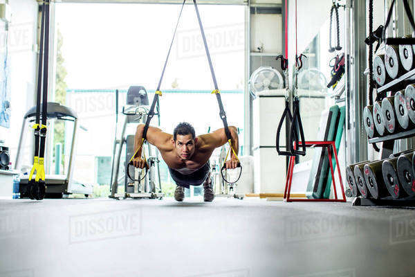 Pacific Islander man working out in gym - Stock Photo - Dissolve