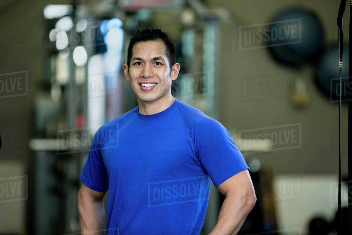 Pacific Islander man smiling in gym - Stock Photo - Dissolve