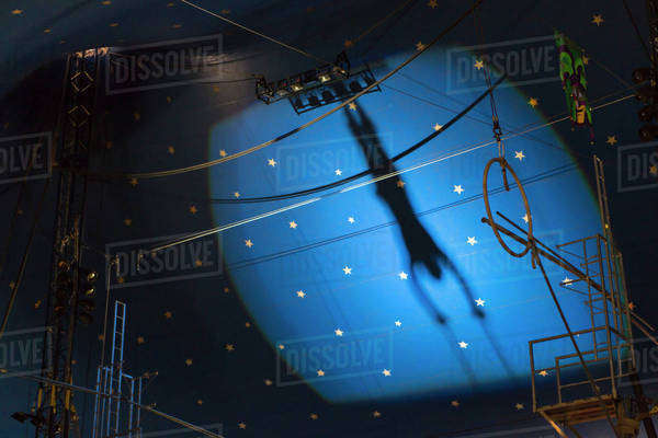 Shadow of acrobat in spotlight on wall - Royalty-free Stock Photo ...