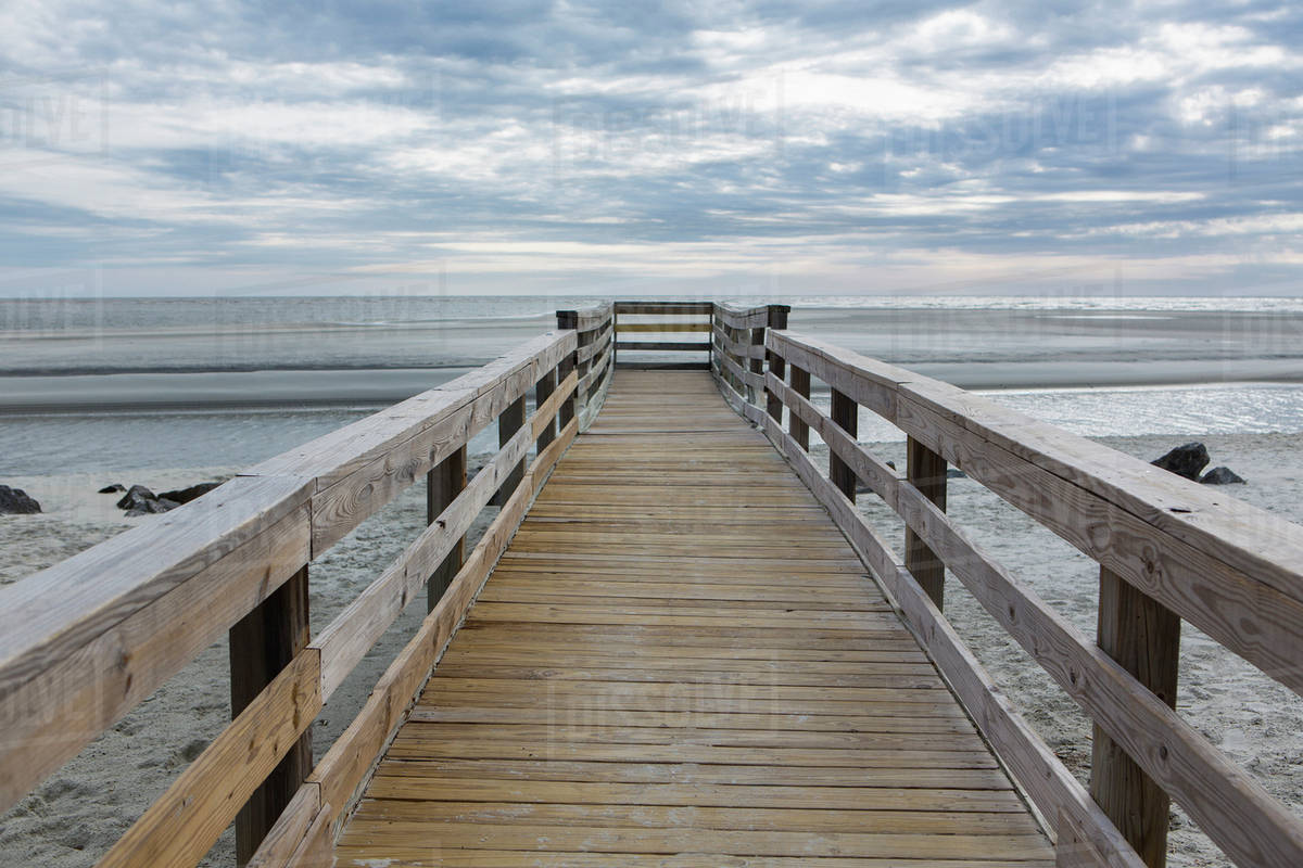 Wooden pier over beach - Stock Photo - Dissolve