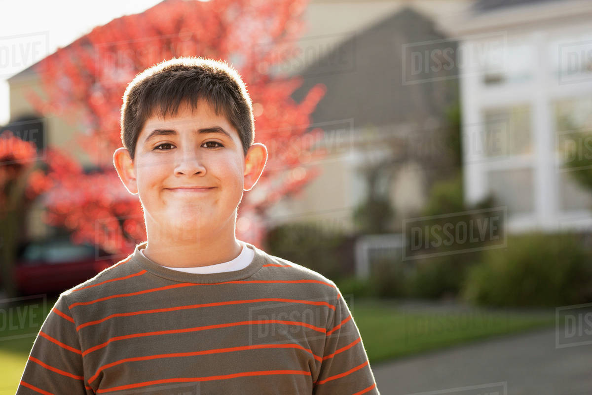 Hispanic boy smiling outdoors - Royalty-free Stock Photo | Dissolve