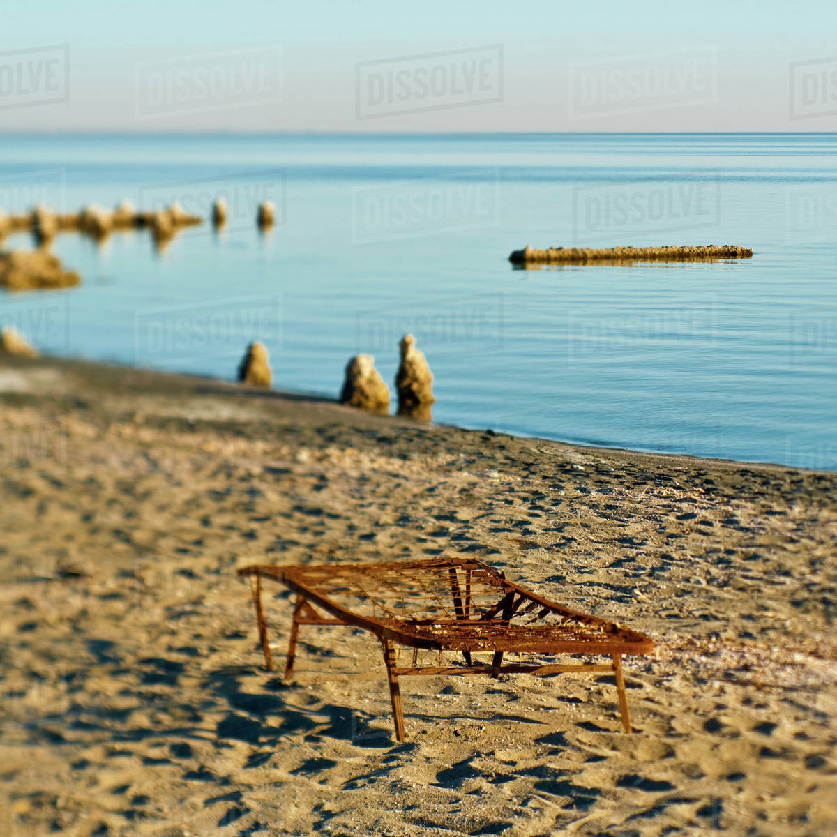 Rusty Bed on Beach - Stock Photo - Dissolve