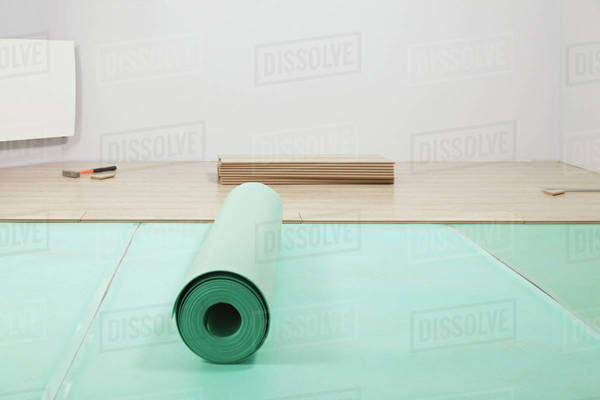 Rolls of underlay, or sub-flooring material, and a partly installed ...