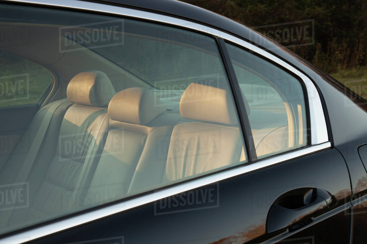 The leather backseat of a car viewed through side window - Royalty-free ...