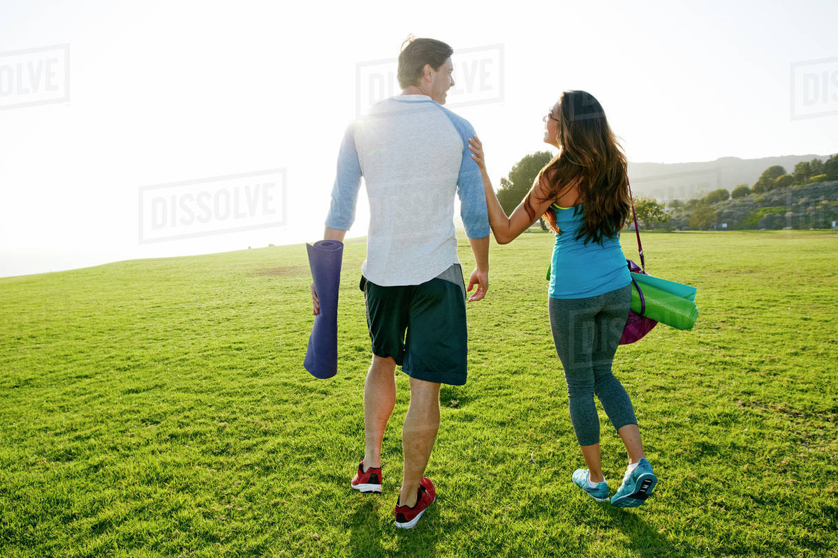 Couple walking together in park - Royalty-free Stock Photo | Dissolve