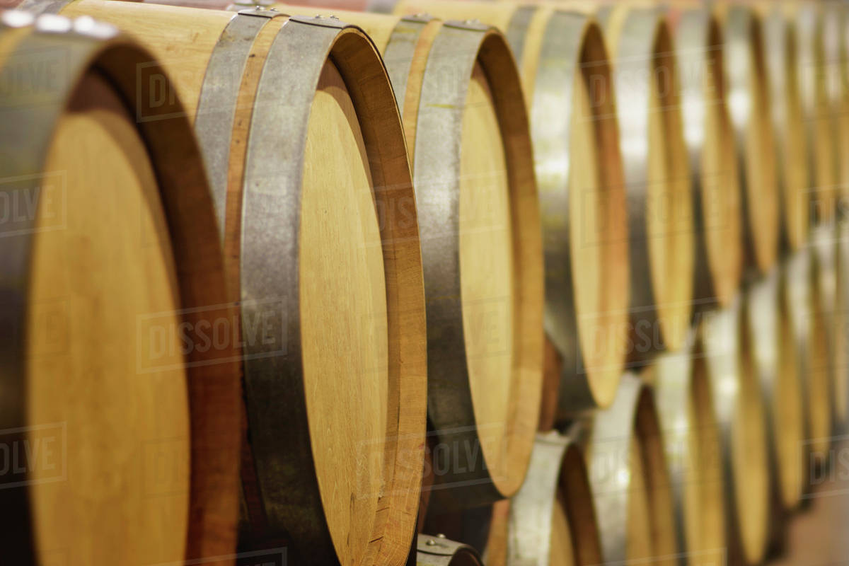 Close up of wine barrels in cellar - Royalty-free Stock Photo | Dissolve