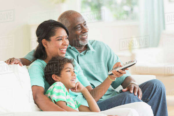 Three generations of family watching tv - Stock Photo - Dissolve