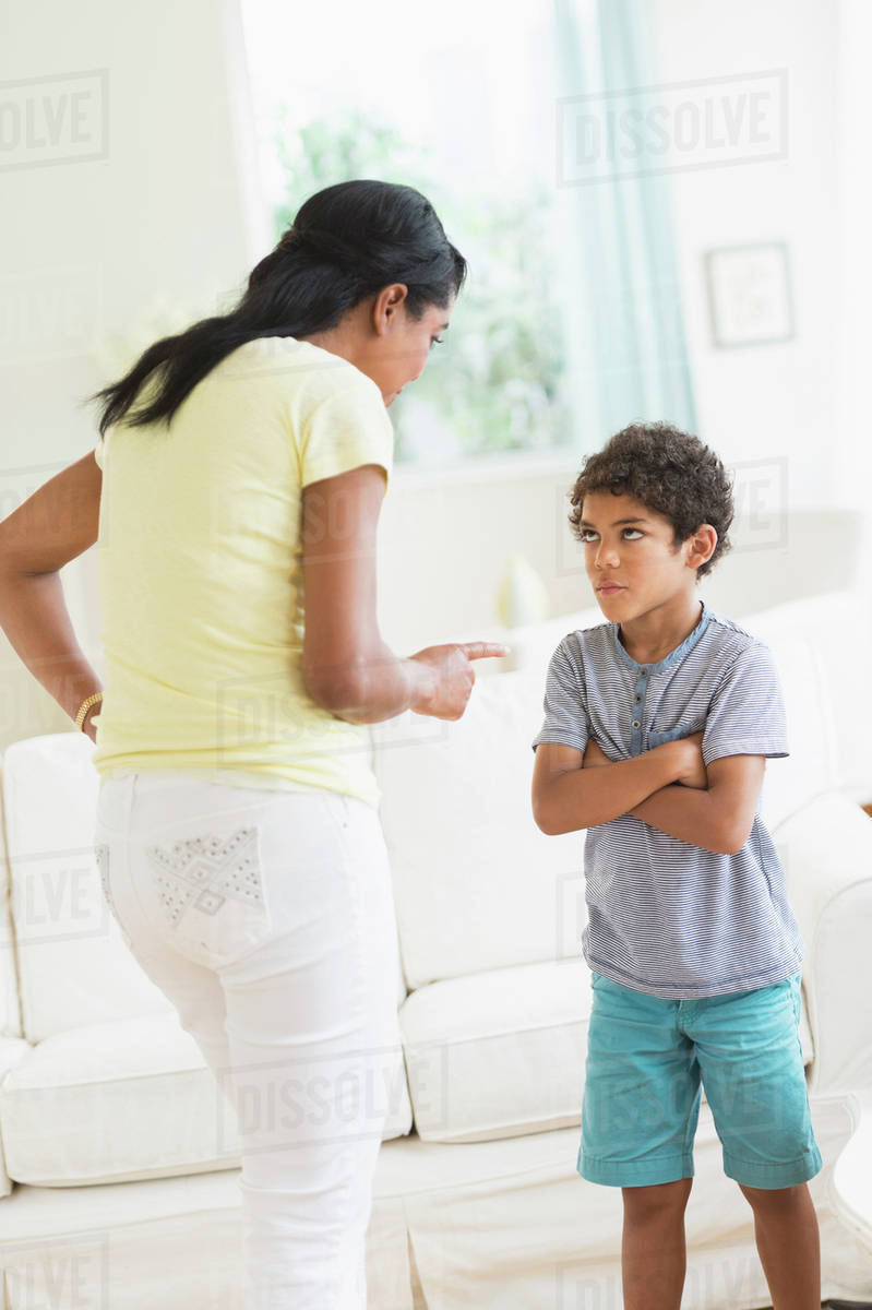 Mother scolding son in living room - Stock Photo - Dissolve