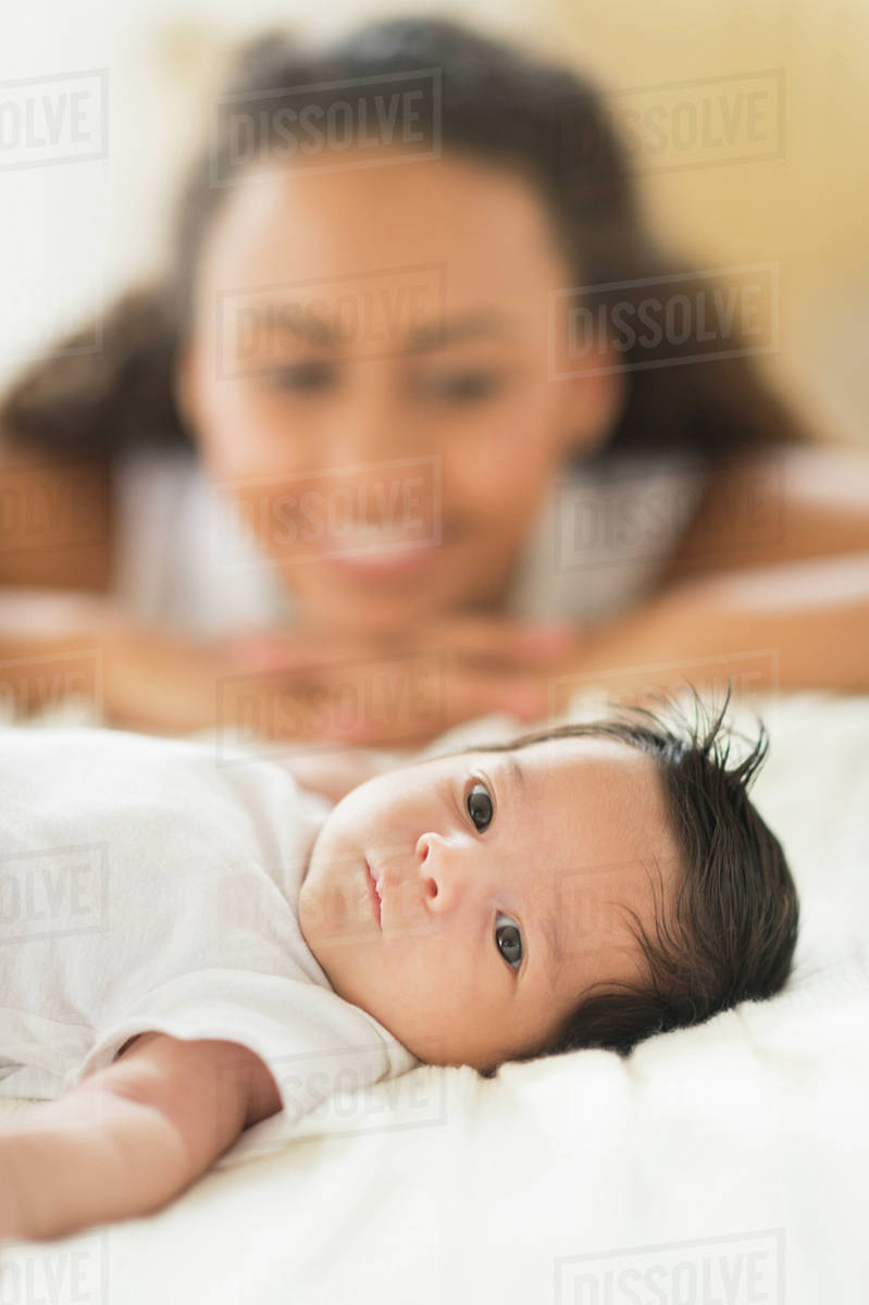 Hispanic mother admiring baby - Royalty-free Stock Photo | Dissolve