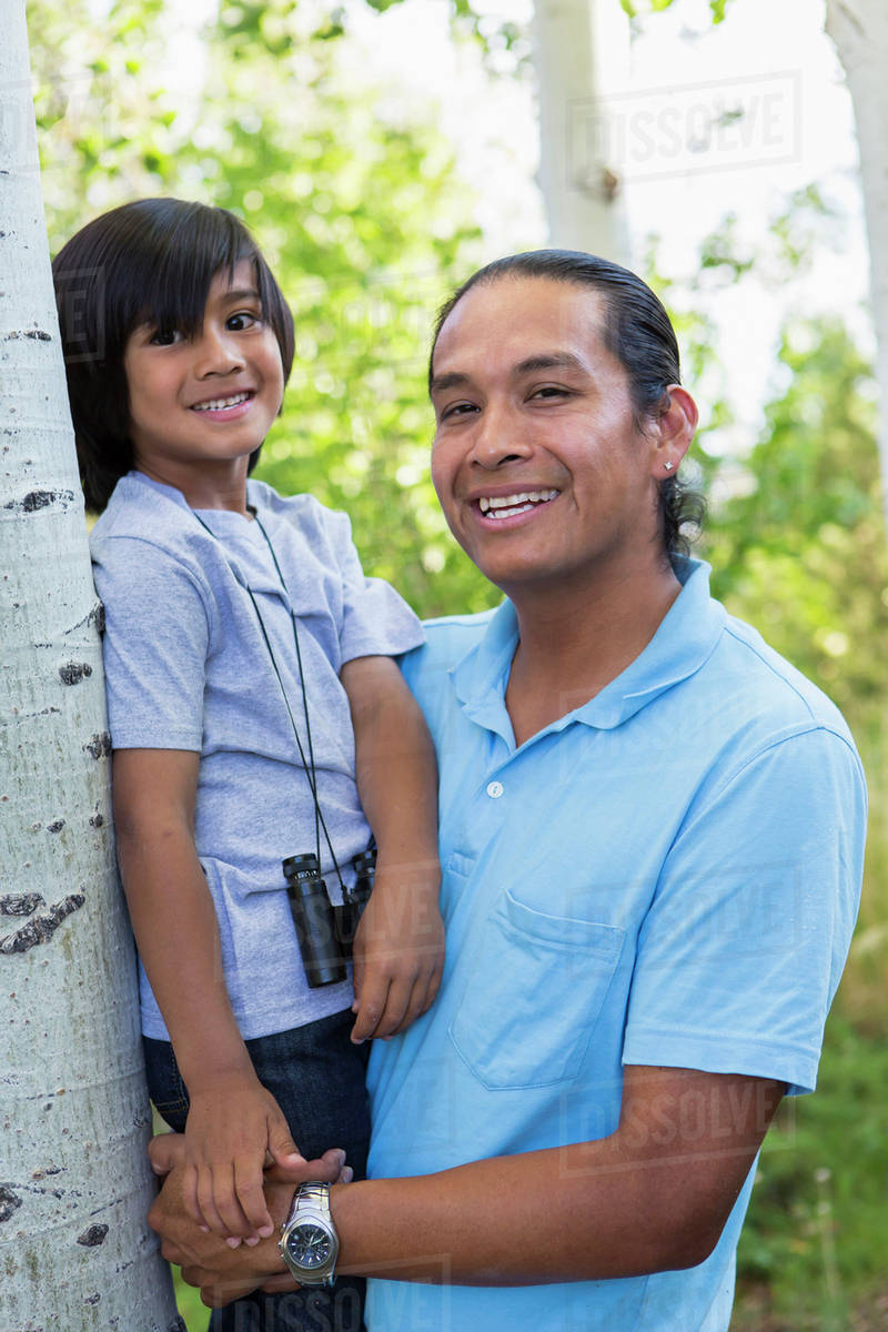 Father holding son outdoors - Royalty-free Stock Photo | Dissolve