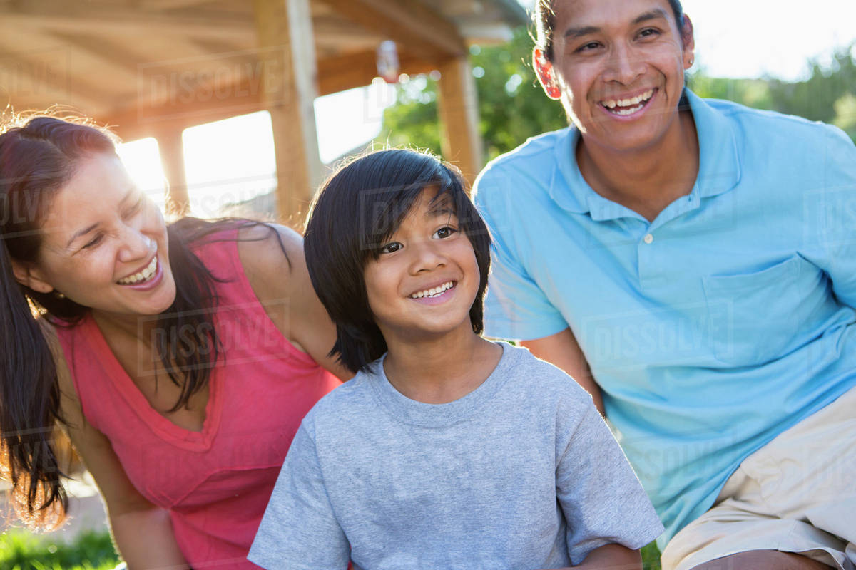 Family smiling outdoors - Royalty-free Stock Photo | Dissolve