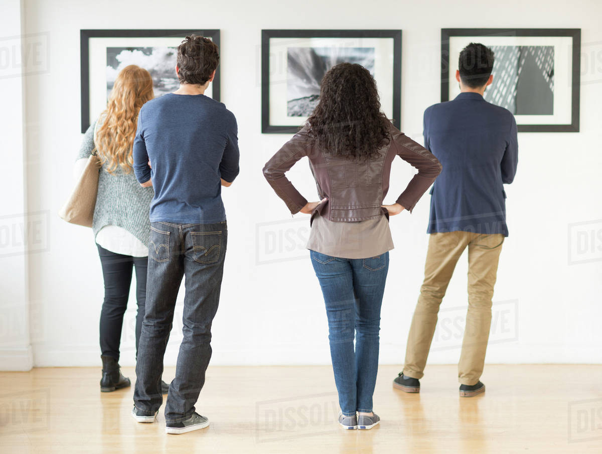 Couples admiring art in gallery - Royalty-free Stock Photo | Dissolve