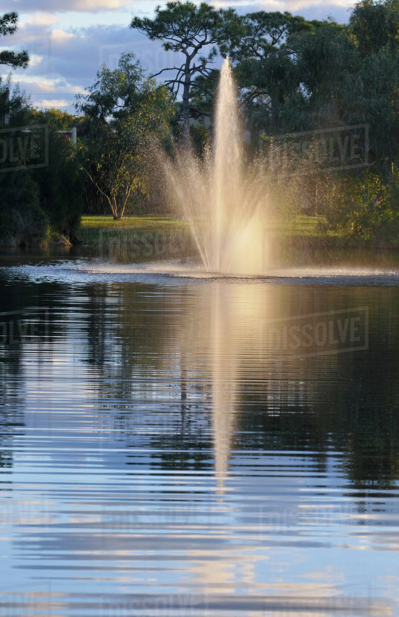Fountain splashing in pond - Royalty-free Stock Photo | Dissolve