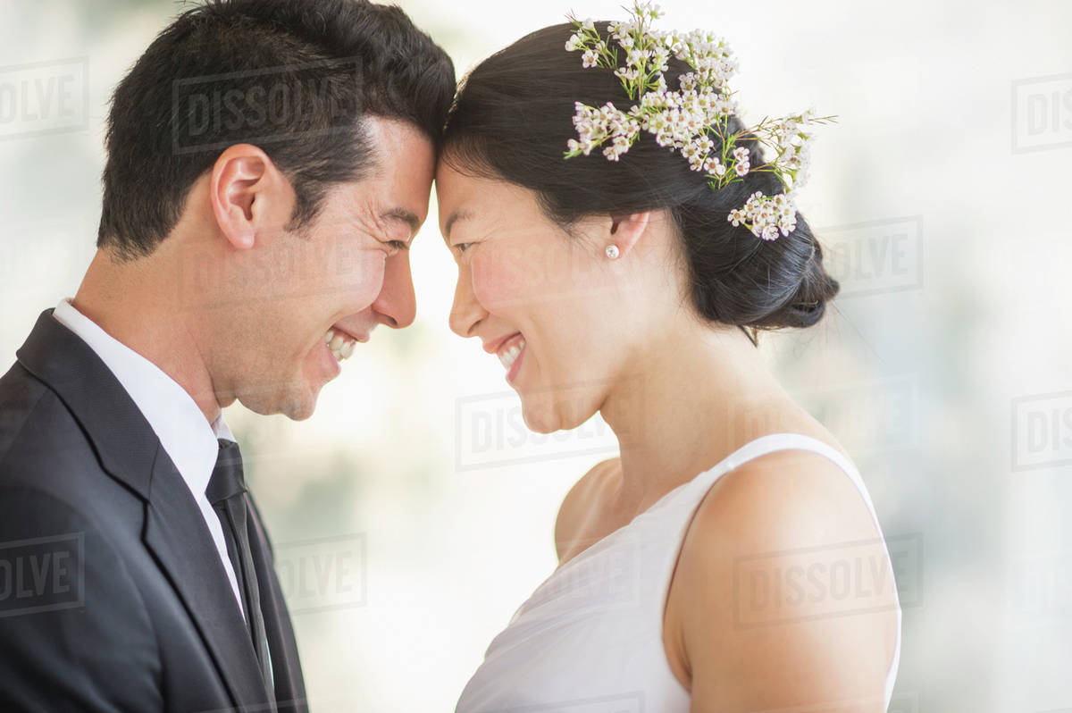 Newlywed couple smiling face to face - Stock Photo - Dissolve